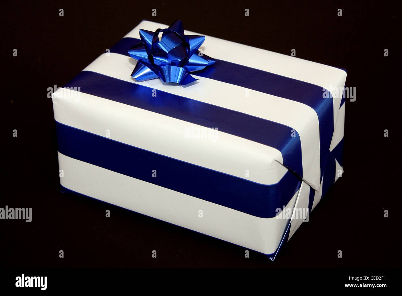A rectangular in white and blue wrapped gift box over black Stock Photo ...