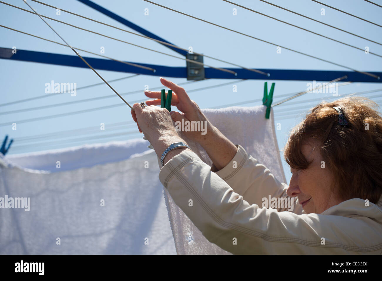 Woman hanging out the laundry hi-res stock photography and images - Alamy