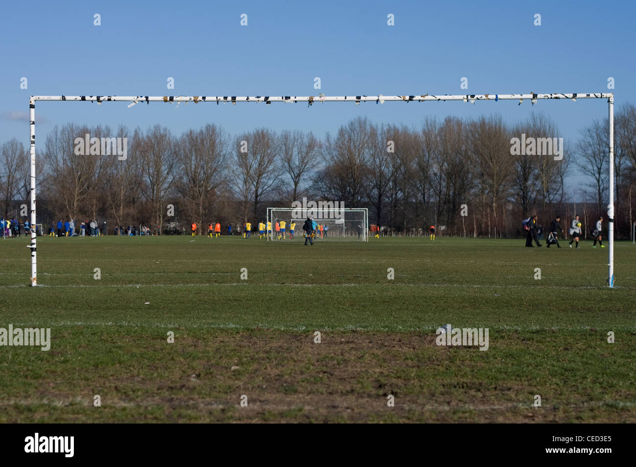 Goal frame posts and cross bar with old tape, no net, goalkeeper, two ...