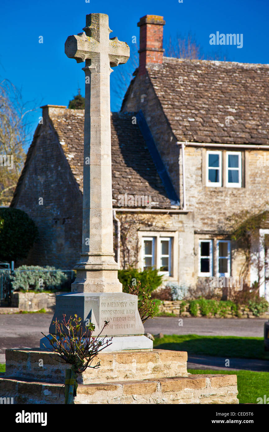 Stone war memorial on the green in the Cotswold village of Biddestone ...