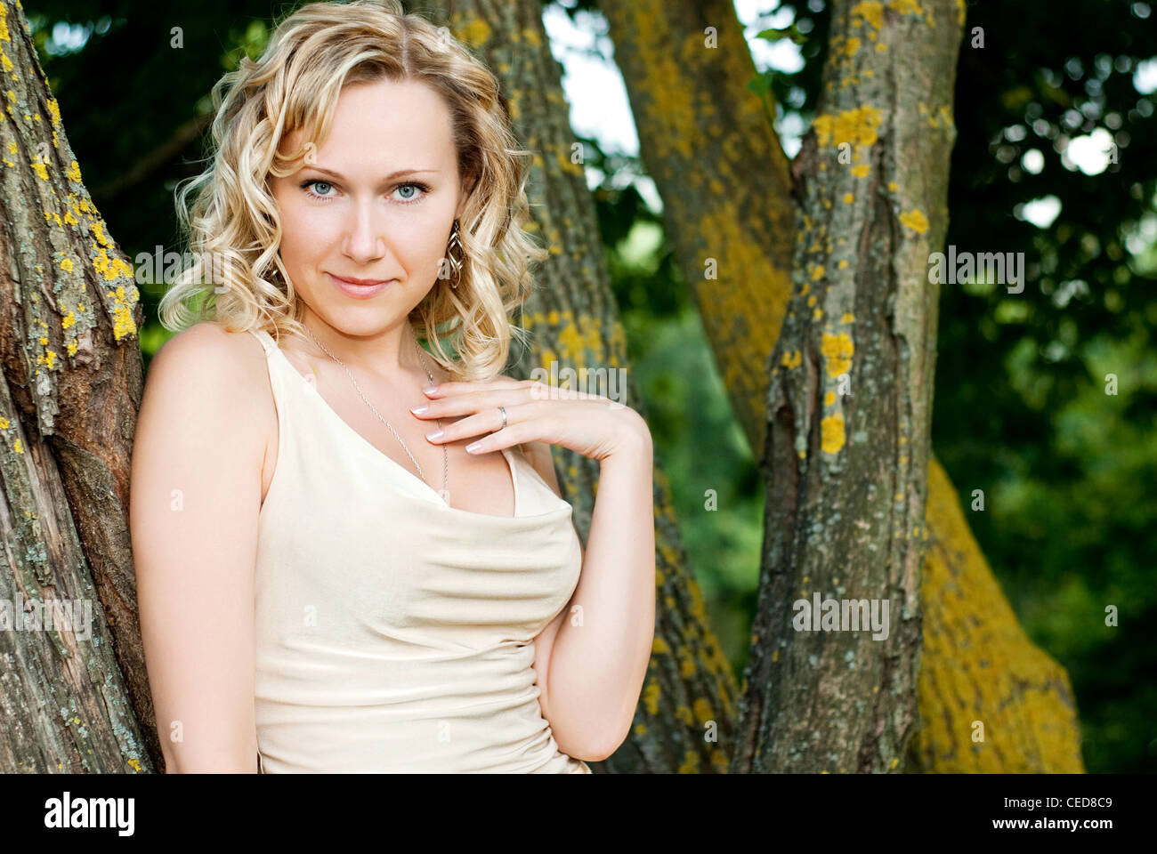 Portrait of charming model near tree Stock Photo - Alamy
