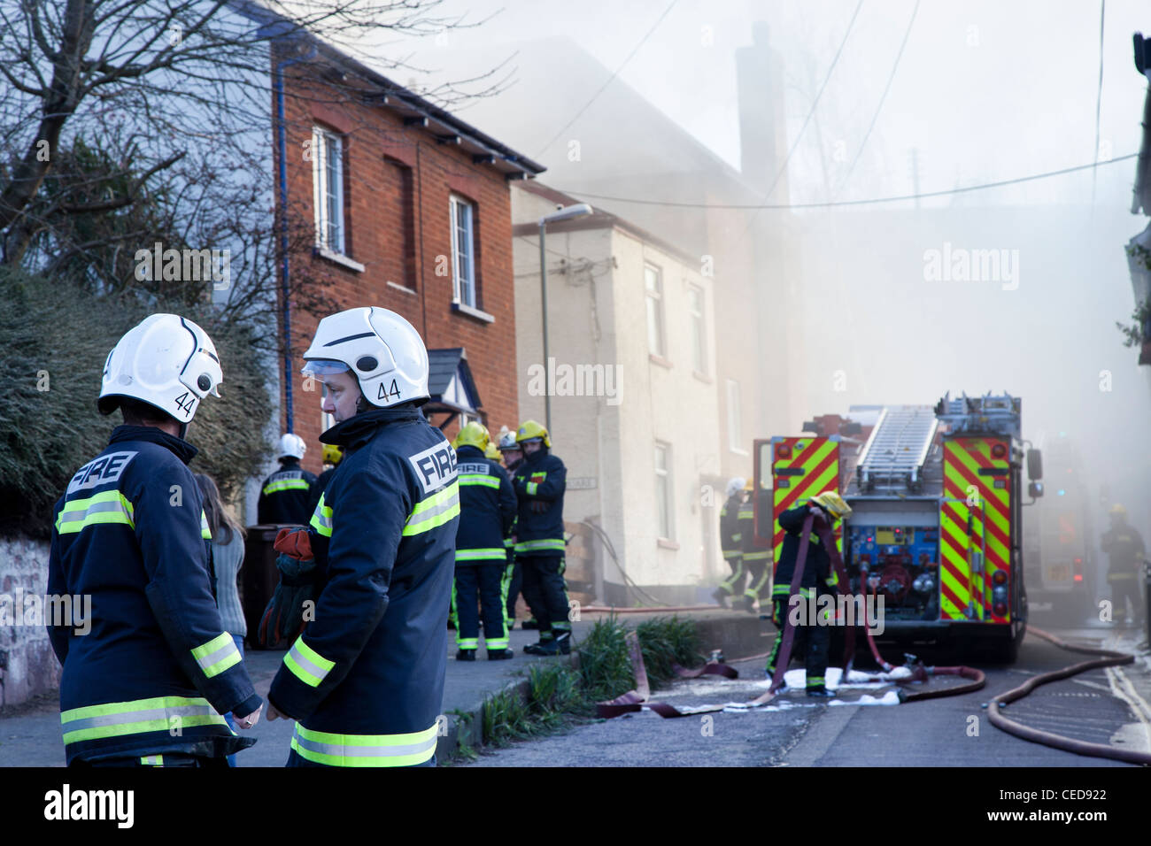 Fire fighters at a fire in a row of thatched cottages in Crediton ...