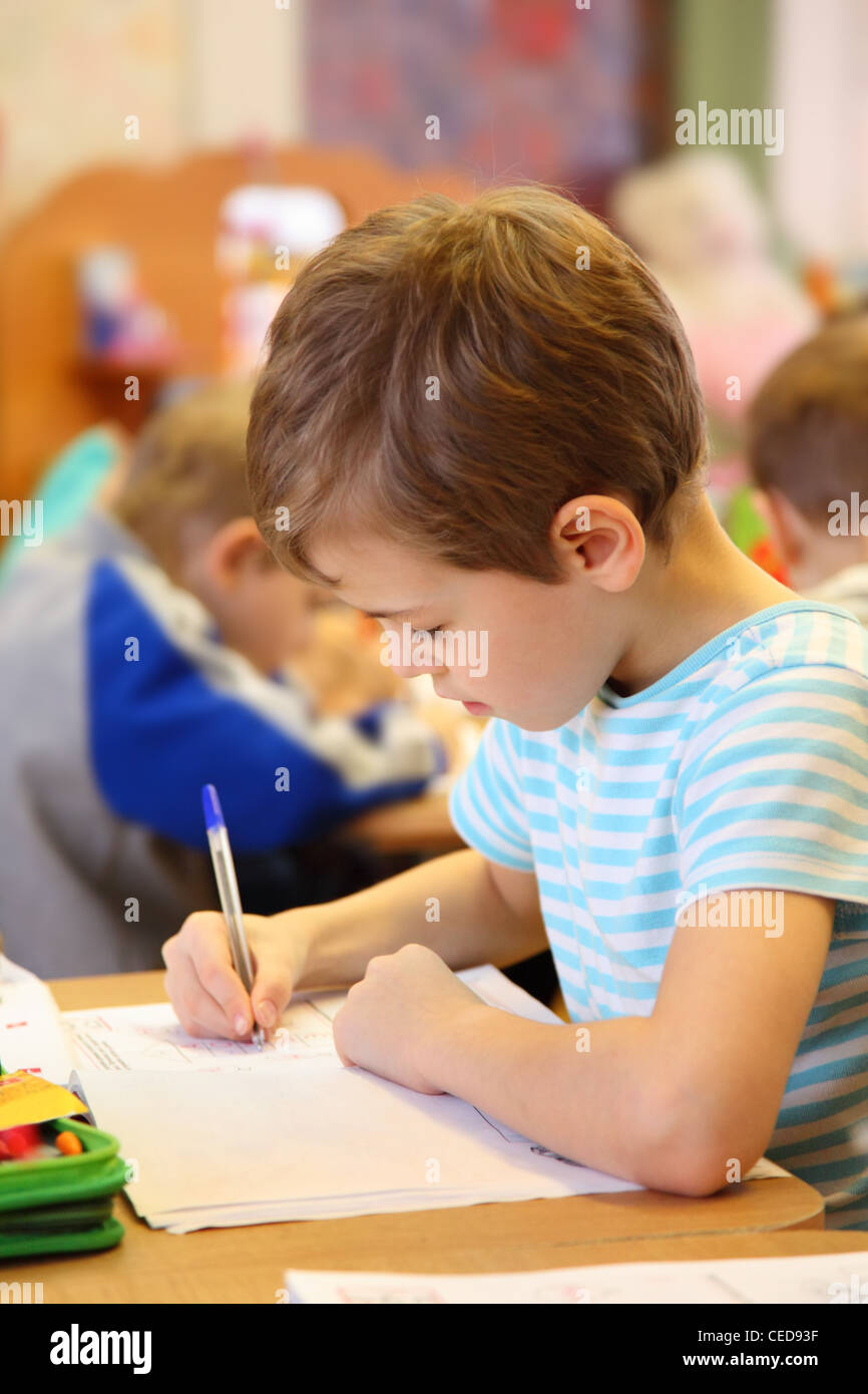 Drawing boy in kindergarten Stock Photo - Alamy