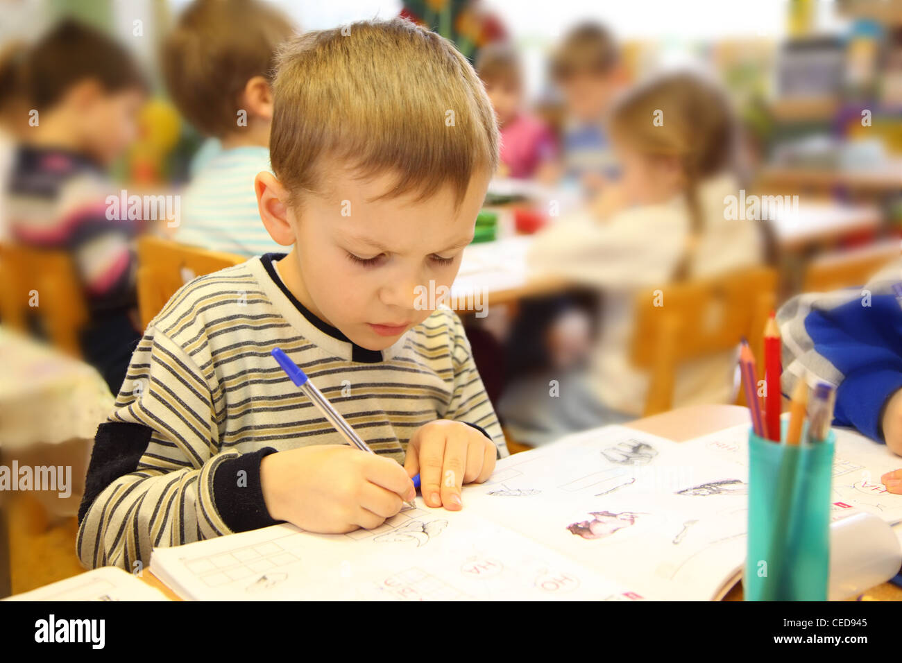 Drawing boy in kindergarten Stock Photo - Alamy