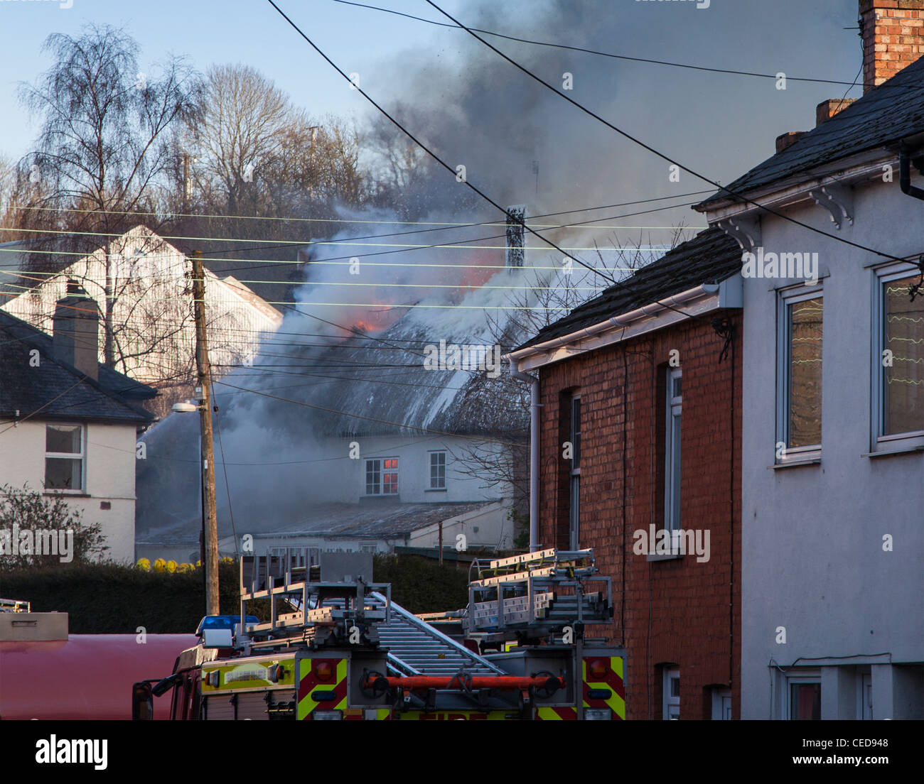 Fire fighters at a fire in a row of thatched cottages in Crediton ...