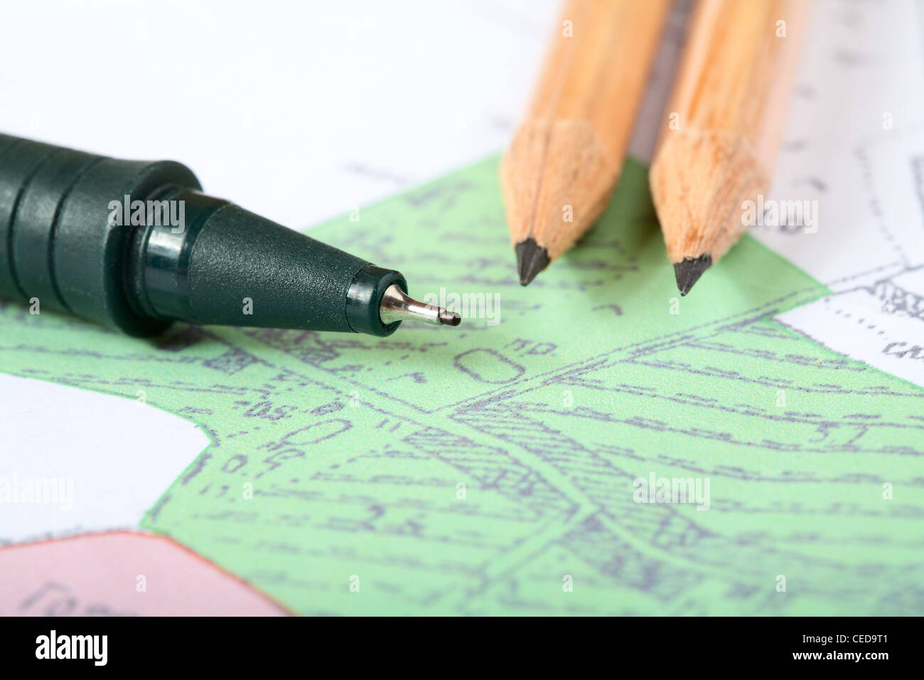 Pencils and marker on a topographic map Stock Photo - Alamy
