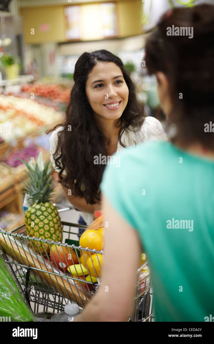 Women talking in grocery store Stock Photo - Alamy