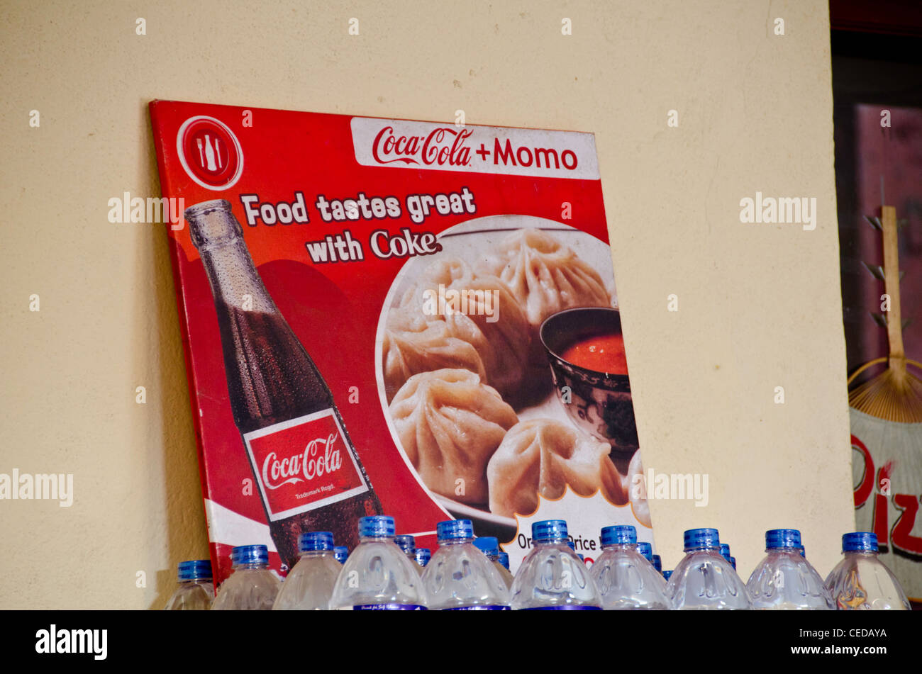 Coke being advertised with Nepali ethnic foods Stock Photo - Alamy