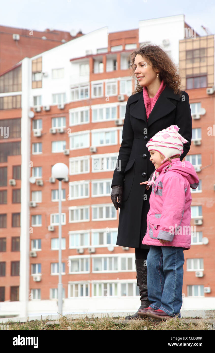 Mother with child and new building Stock Photo - Alamy