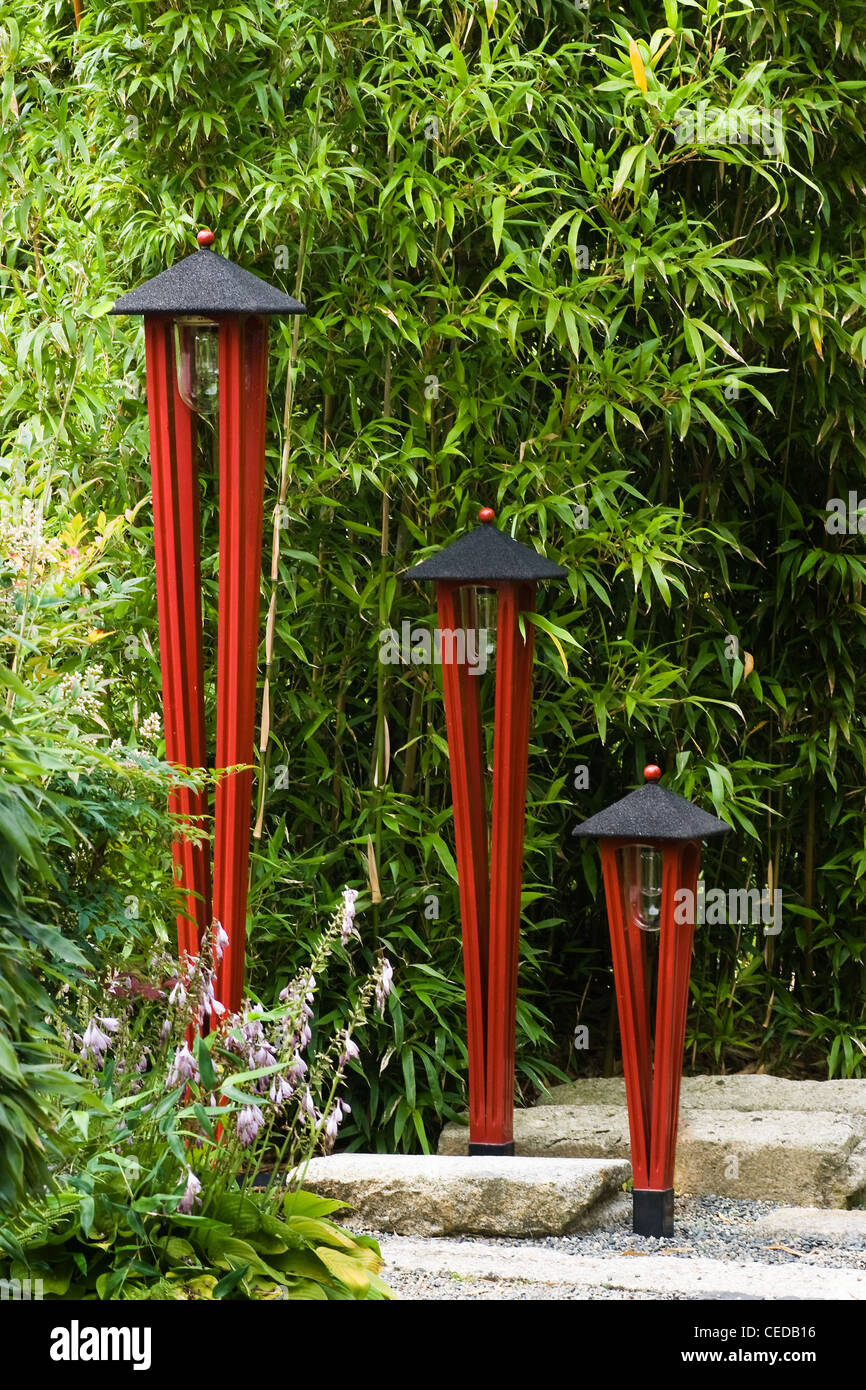 Red painted wooden lamps to illuminate a Japanese garden Stock Photo ...