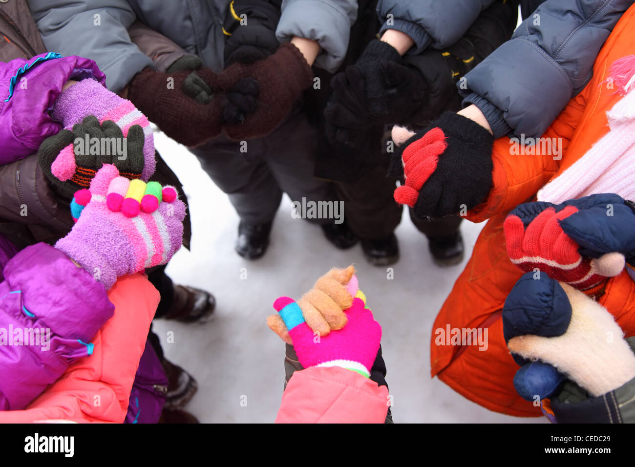 Children stand around having joined hands, top view Stock Photo - Alamy