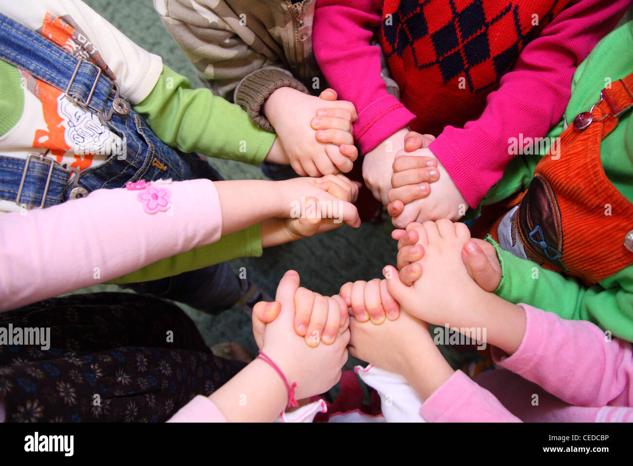 Children stand having joined hands, top view Stock Photo - Alamy