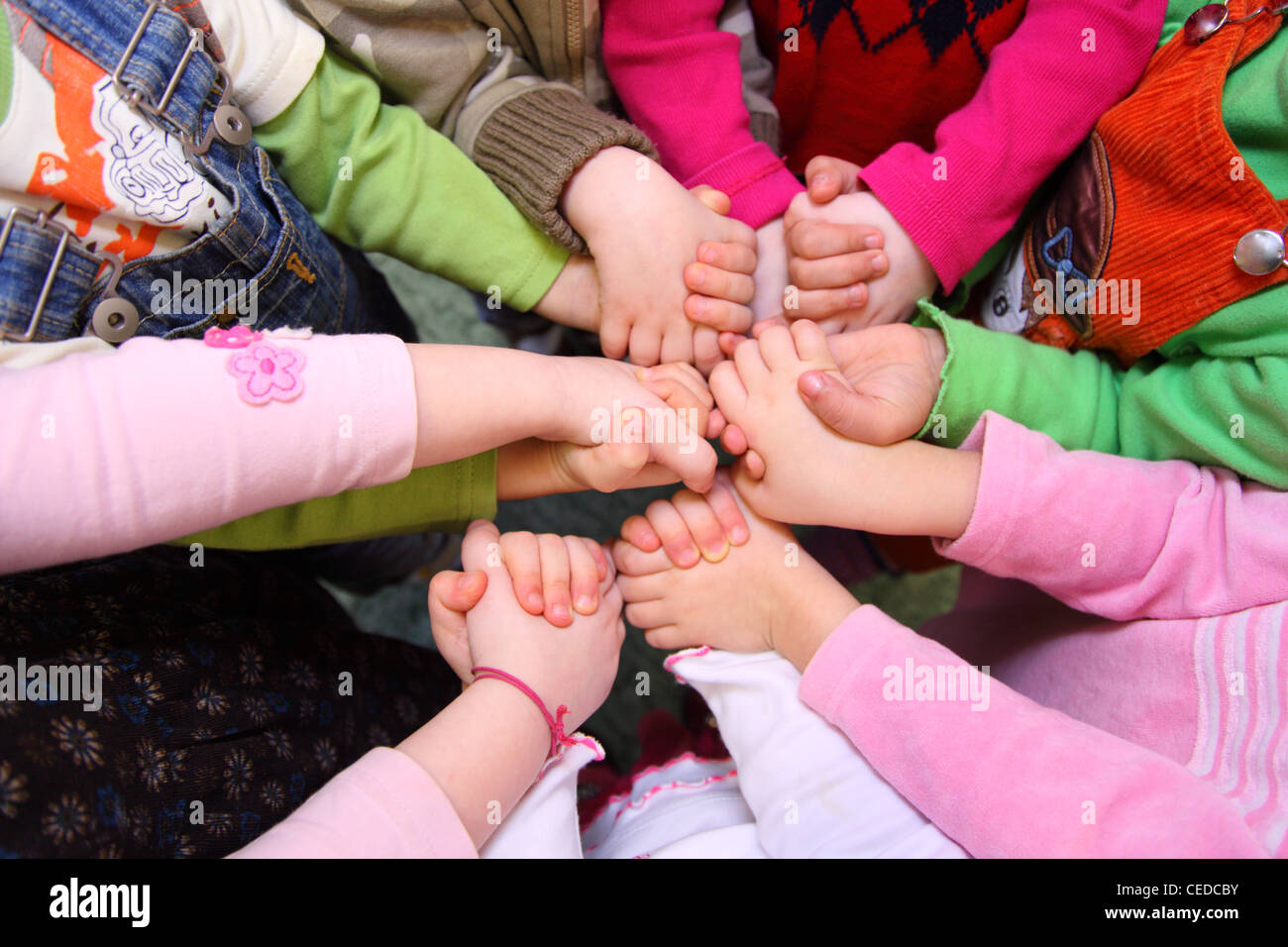 Children stand having joined hands, top view Stock Photo - Alamy