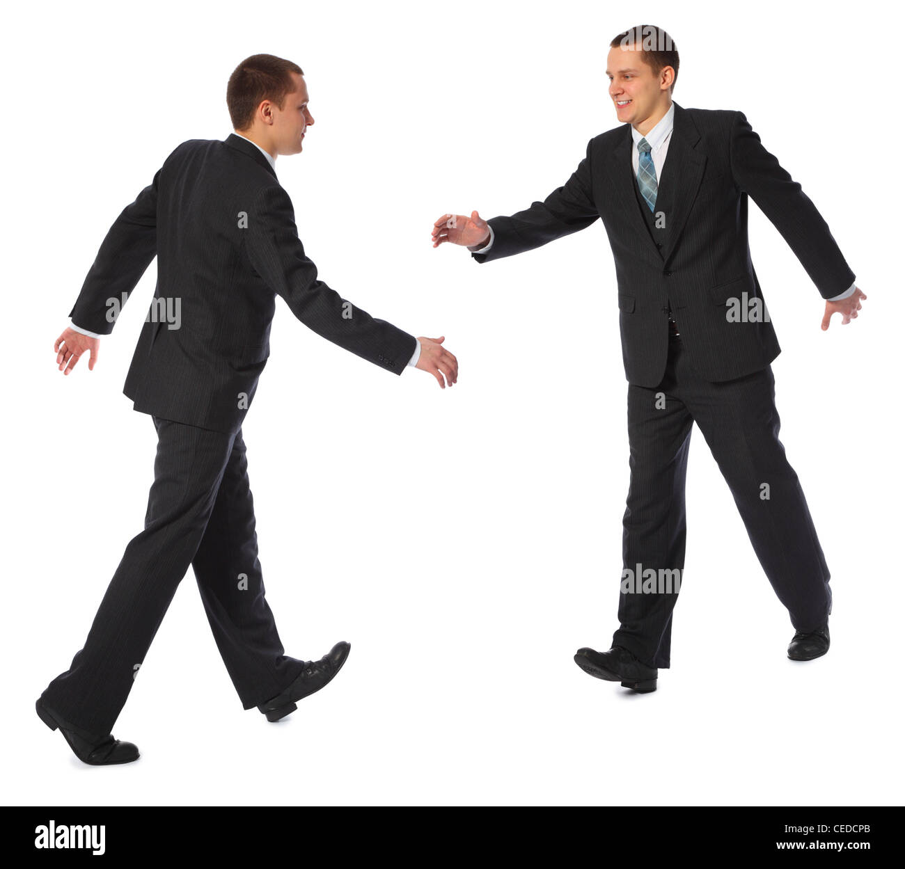 Young walking businessman going handshake Stock Photo - Alamy