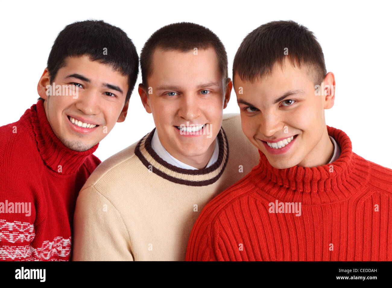 Three smiling friends in sweaters Stock Photo - Alamy