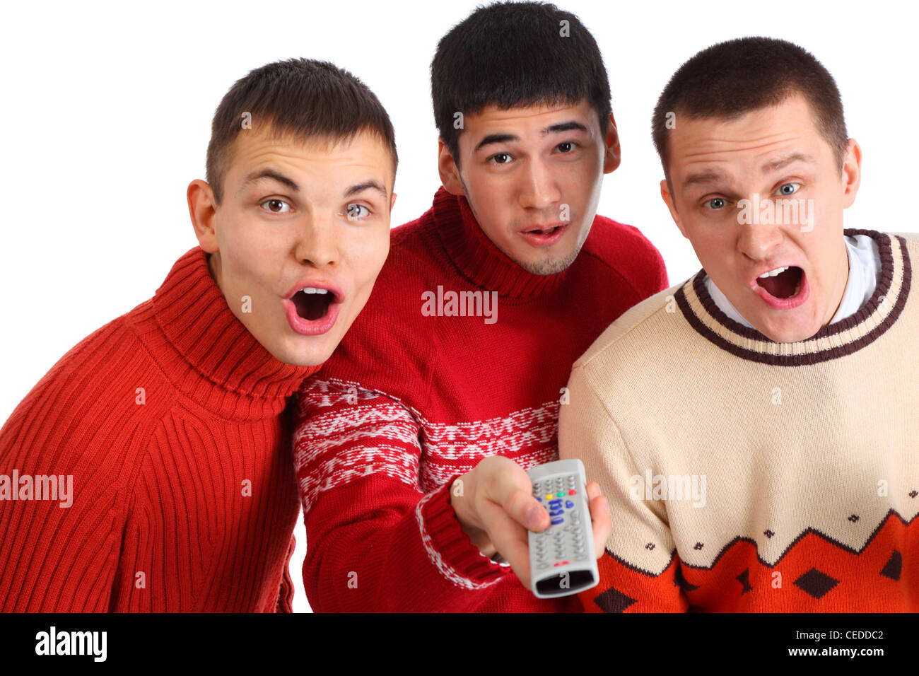Three surprised friends with remote control Stock Photo - Alamy