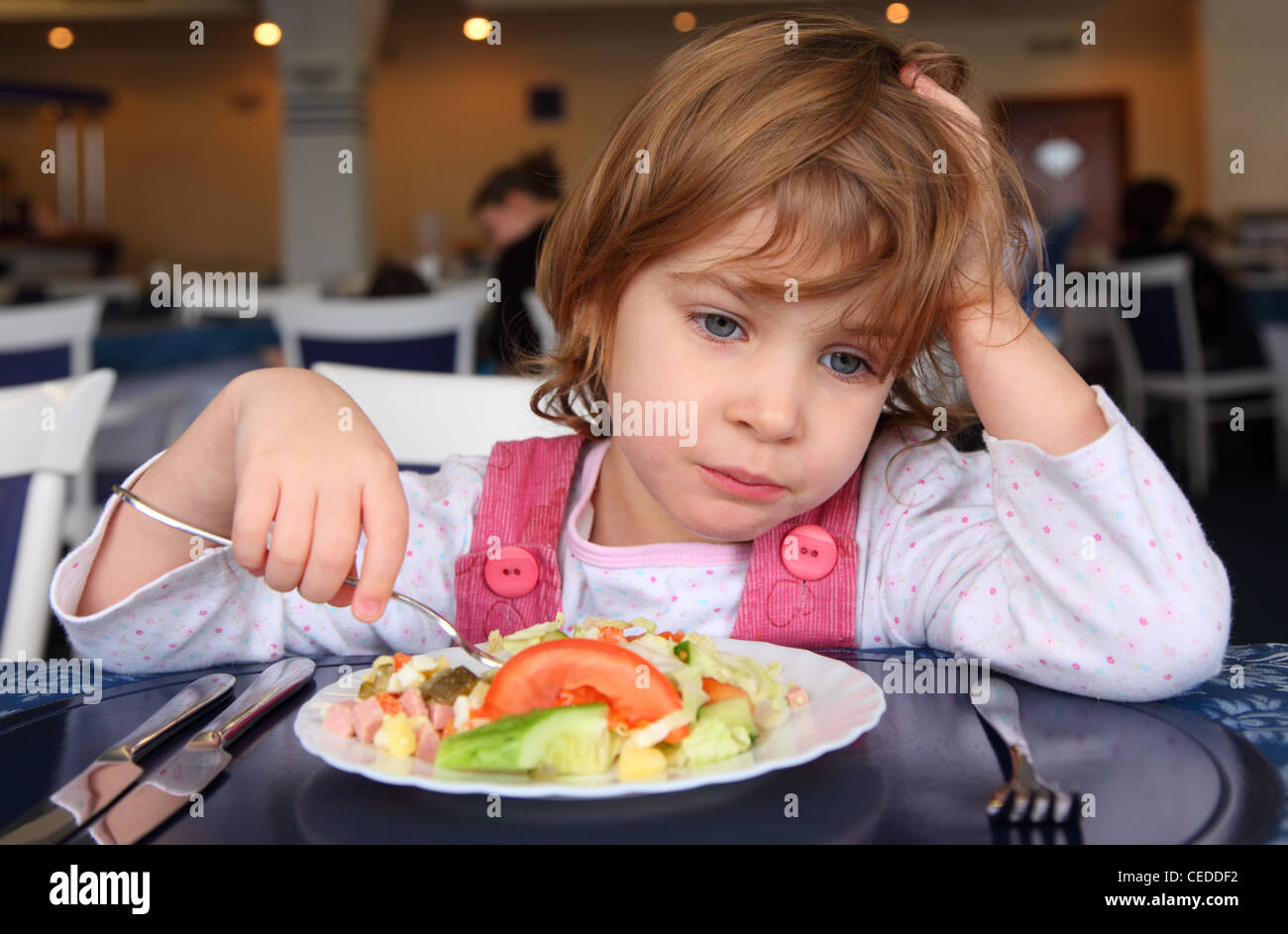 Sad girl behind table in cafe Stock Photo - Alamy