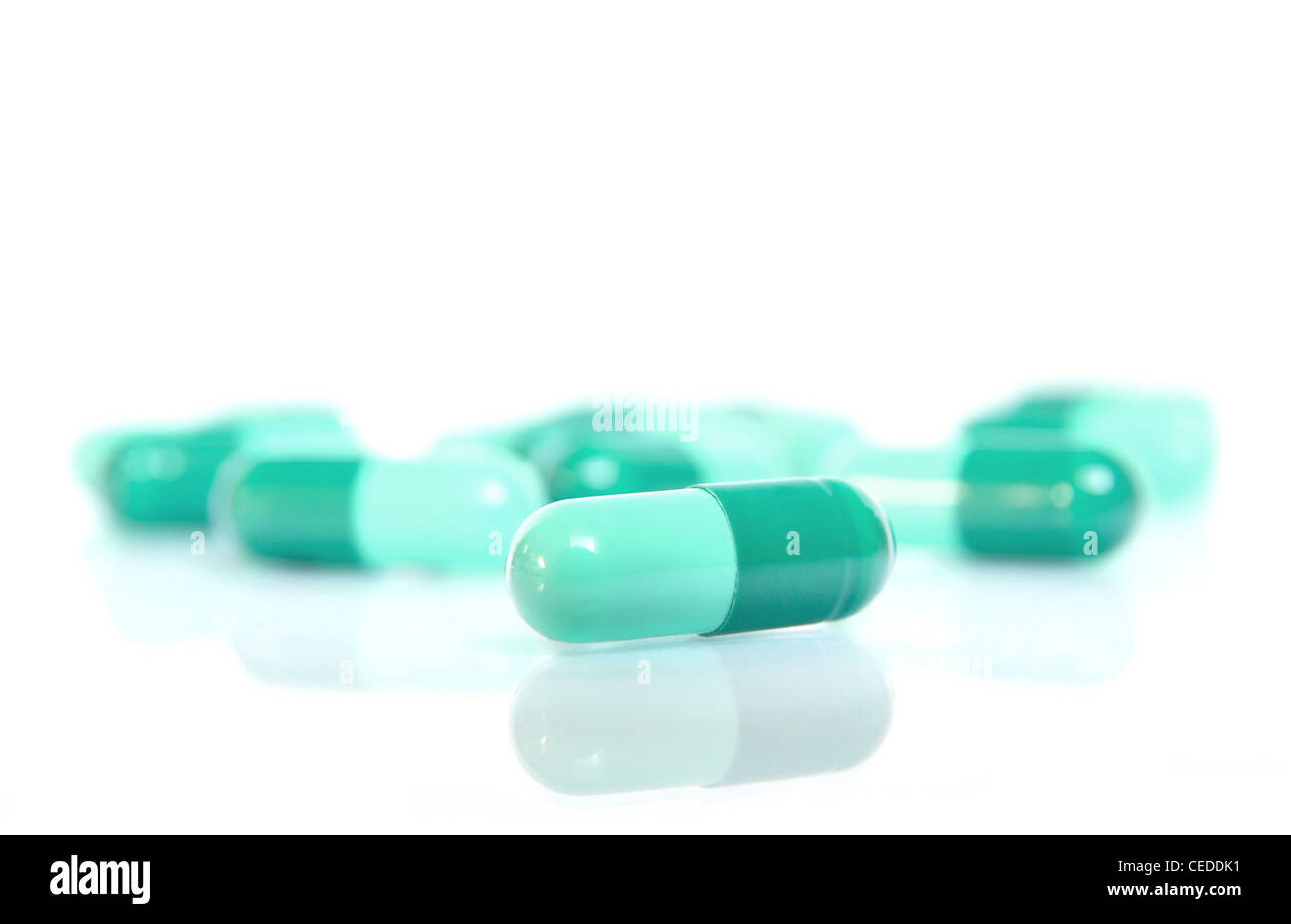 Group of green tablets on white background Stock Photo - Alamy