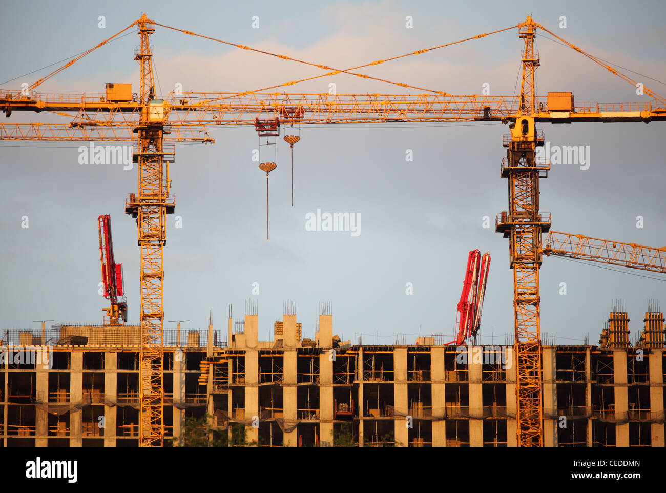 Two cranes on building building Stock Photo - Alamy