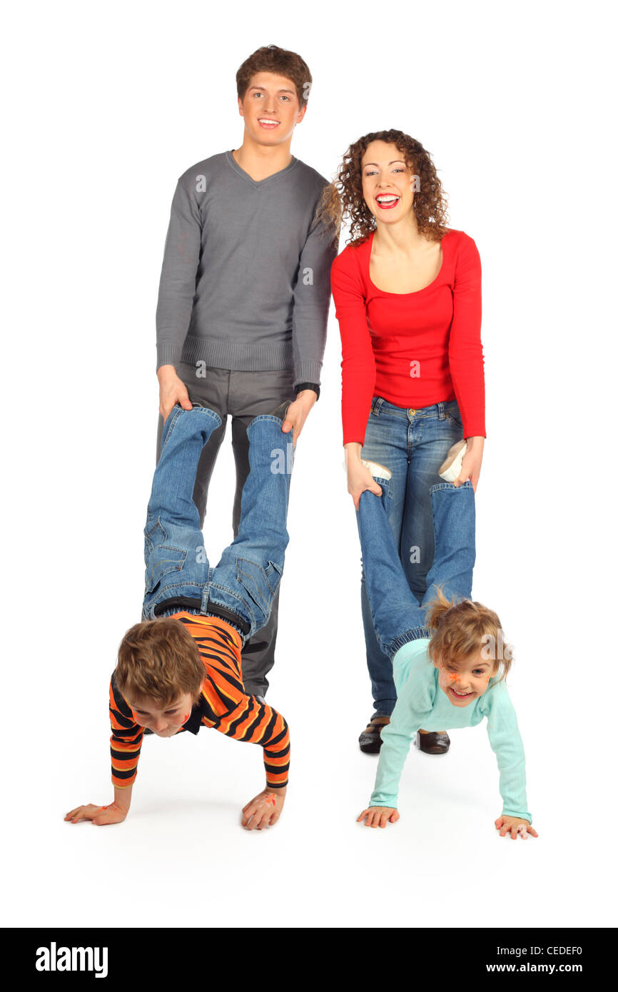 parents hold children for legs, focus on little girl Stock Photo - Alamy