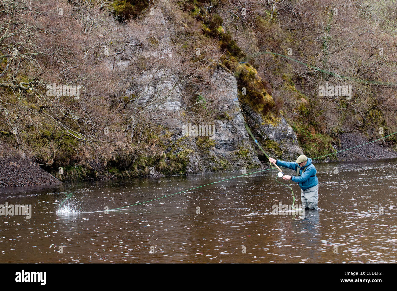 Fisherman fly-fishing in the River Oykel, Sutherland, Scotland, UK ...