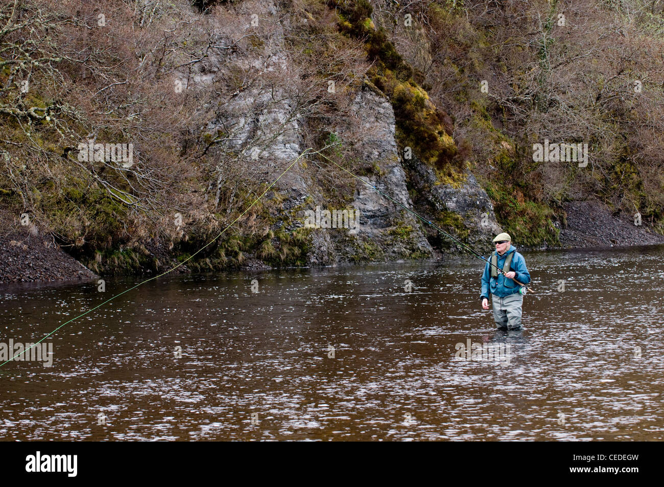 Fisherman fly-fishing in the River Oykel, Sutherland, Scotland, UK ...