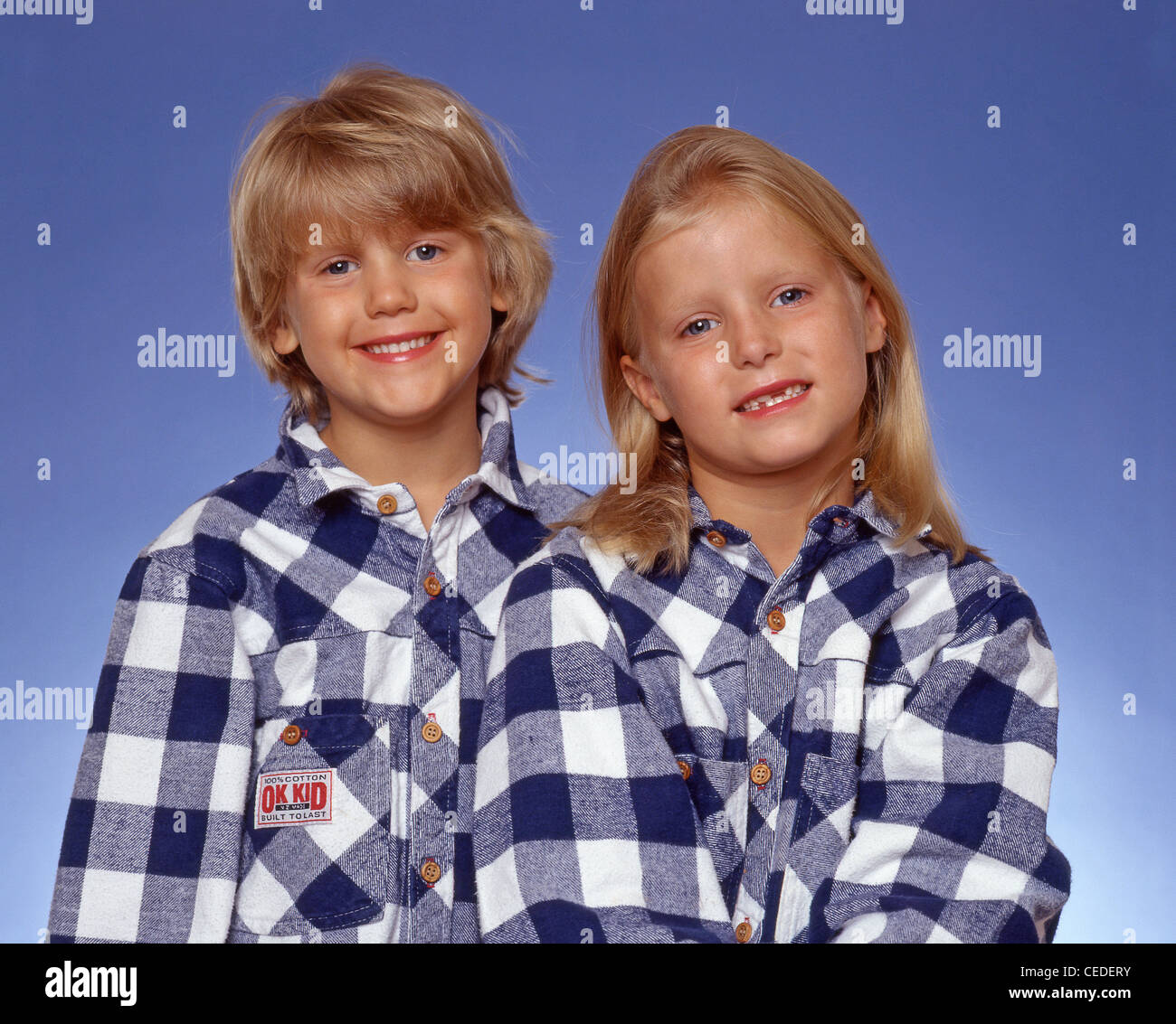 Sisters posing in studio, Winkfield, Berkshire, England, United Kingdom ...