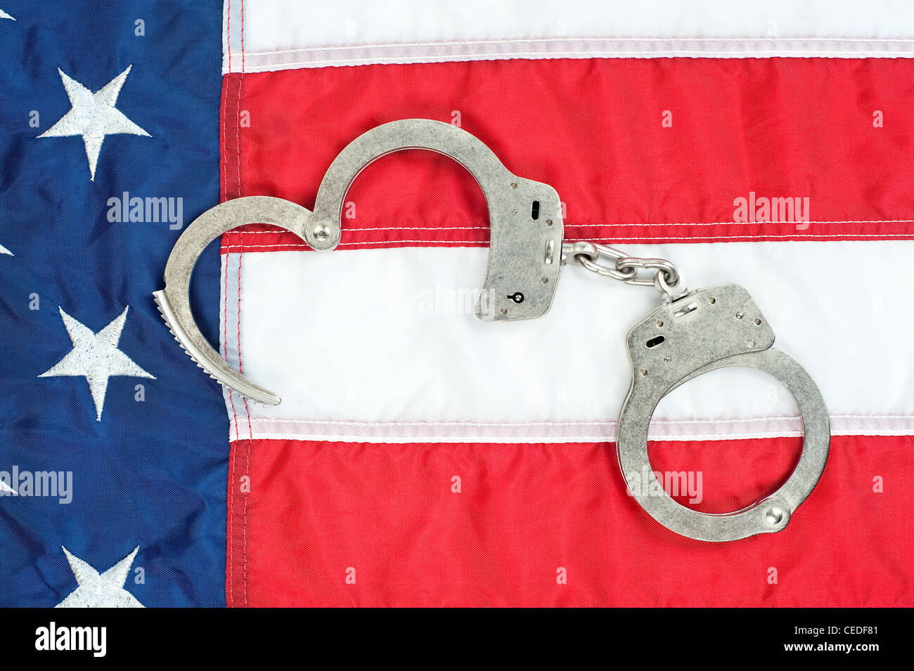 A set of handcuffs on an American flag Stock Photo - Alamy