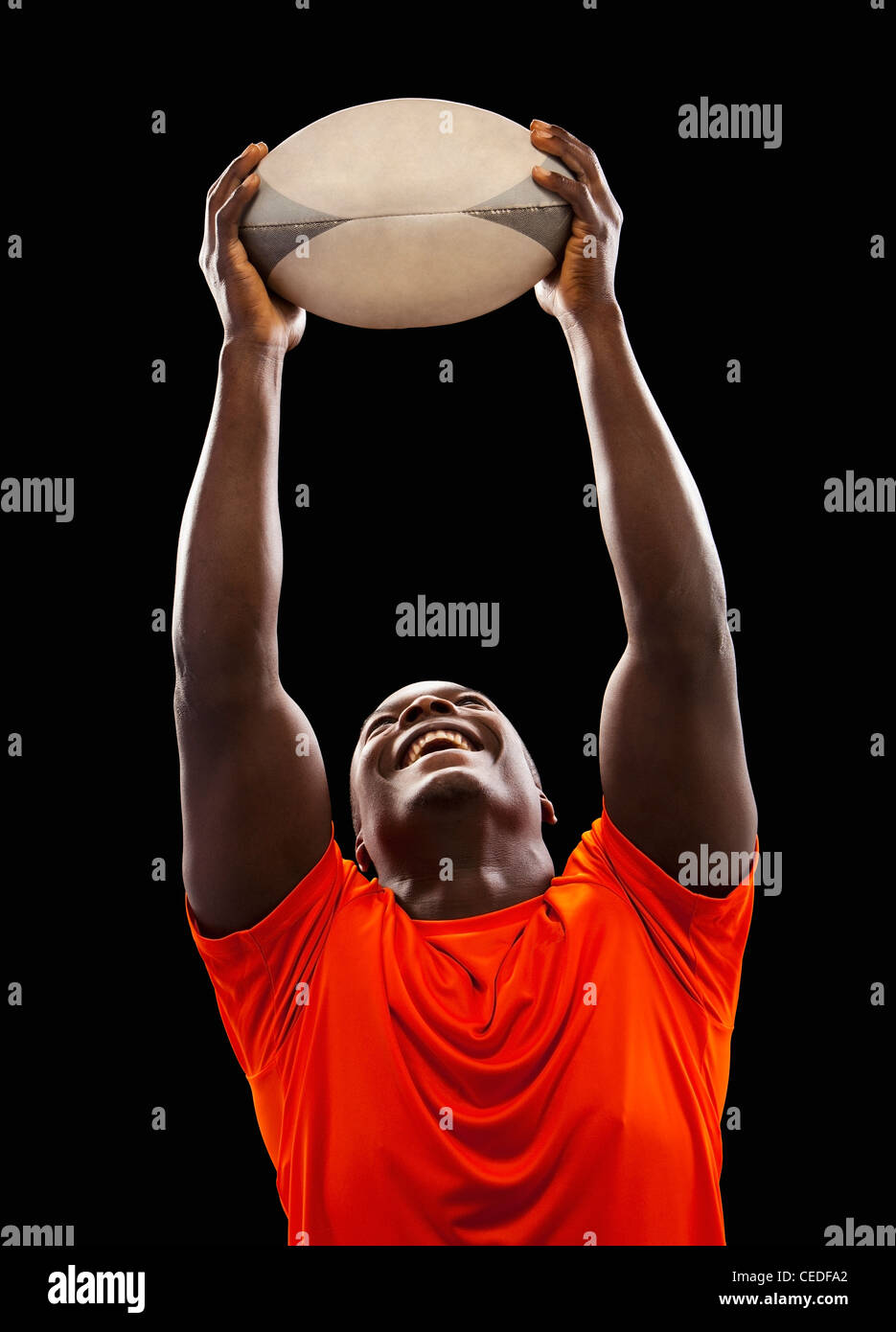 African American man holding rugby ball Stock Photo - Alamy