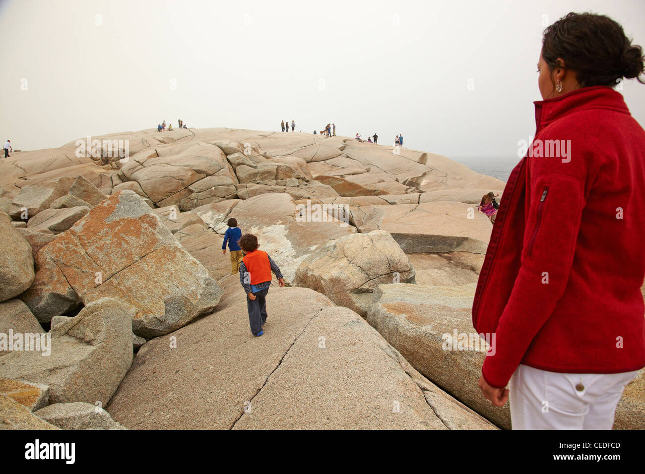 Mother and sons walking on rocks Stock Photo - Alamy