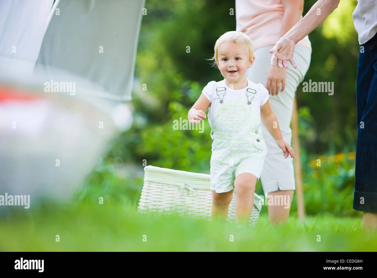 Caucasian baby running in grass Stock Photo - Alamy