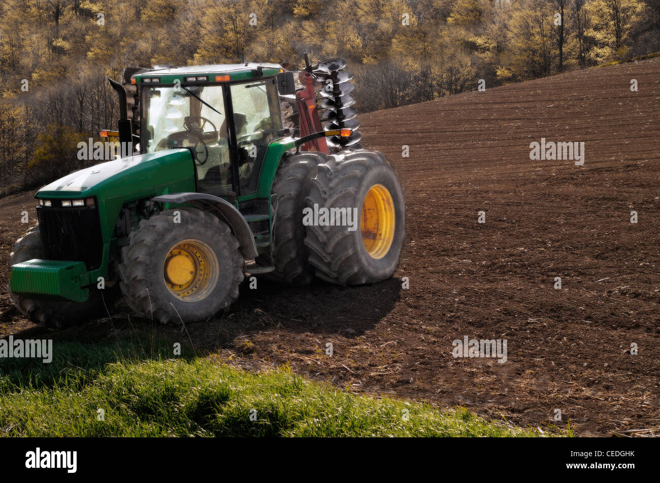 tractor on newly turned field soil Stock Photo - Alamy