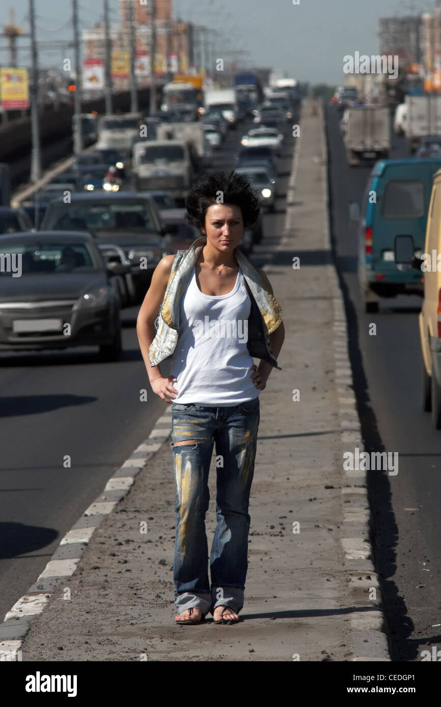 girl standing on highway middle in city Stock Photo - Alamy