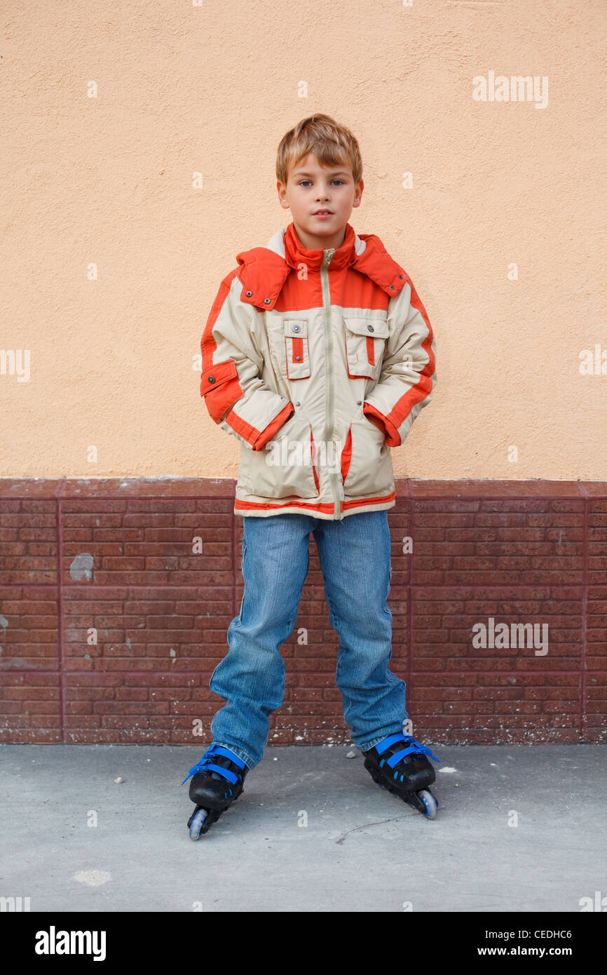 boy standing on roller skates in the yard Stock Photo - Alamy