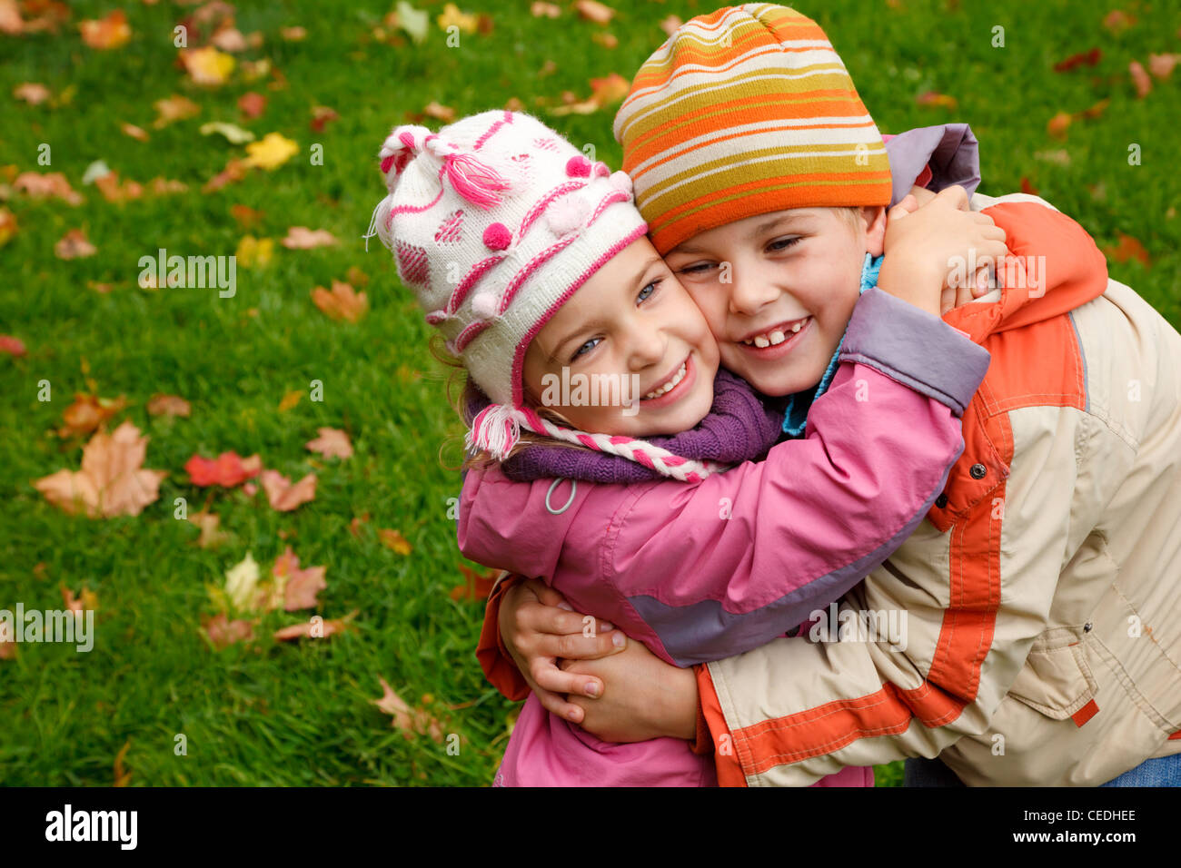 sister and brother embrace in autumnal park Stock Photo - Alamy