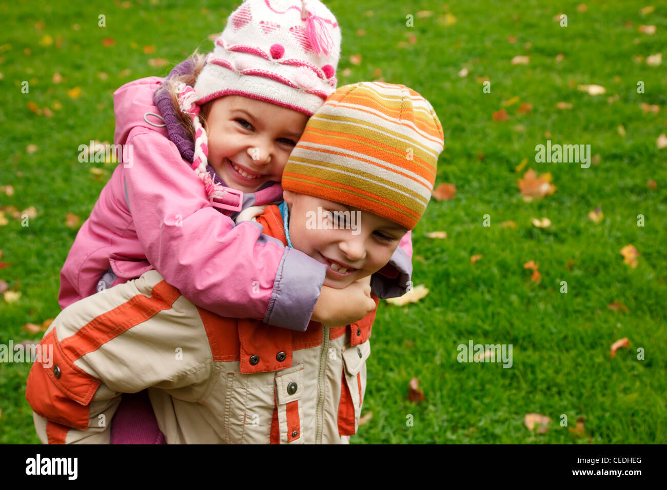 sister on brother's back in autumnal park Stock Photo - Alamy