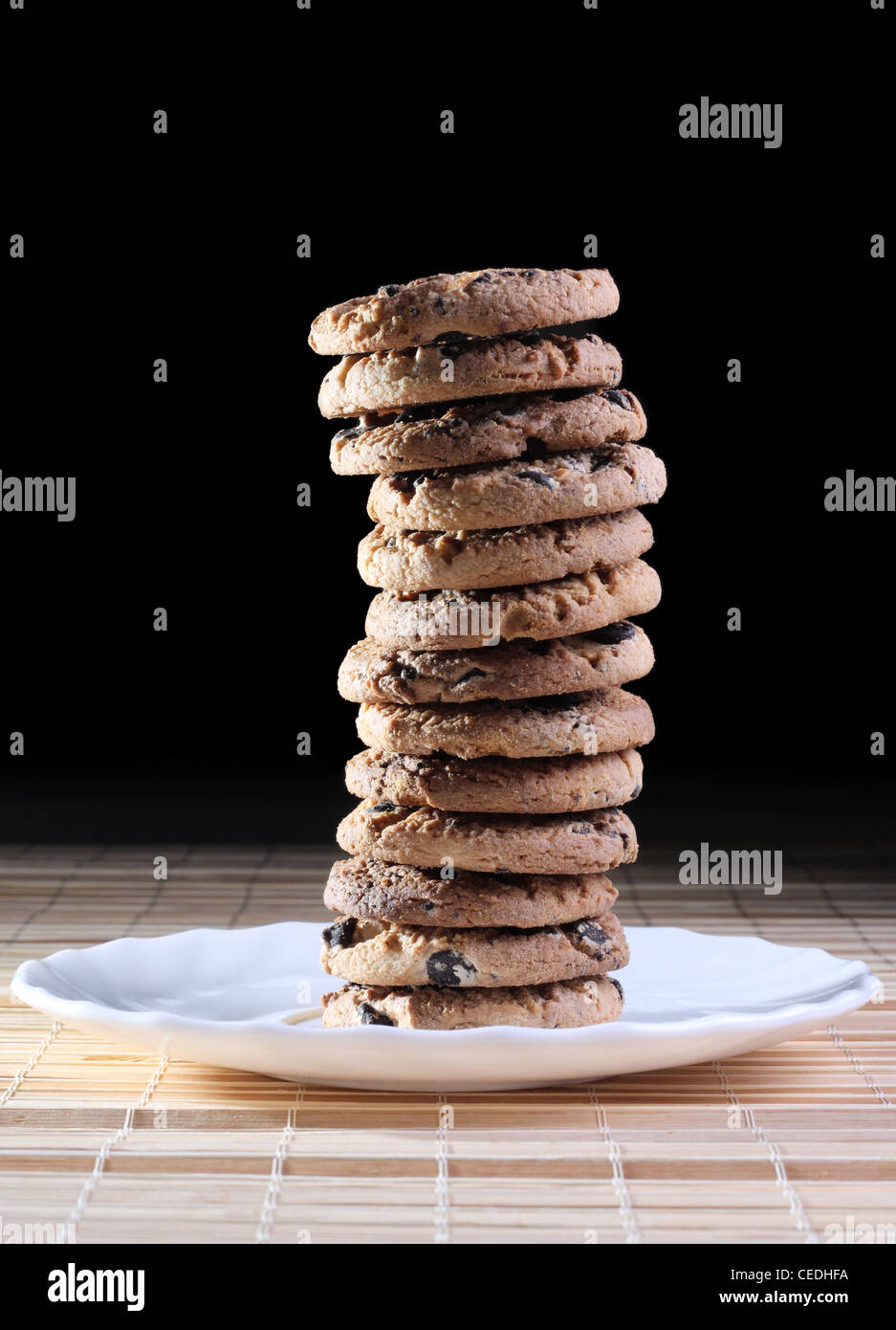 Pile of cookies on the plate at the dark background Stock Photo - Alamy