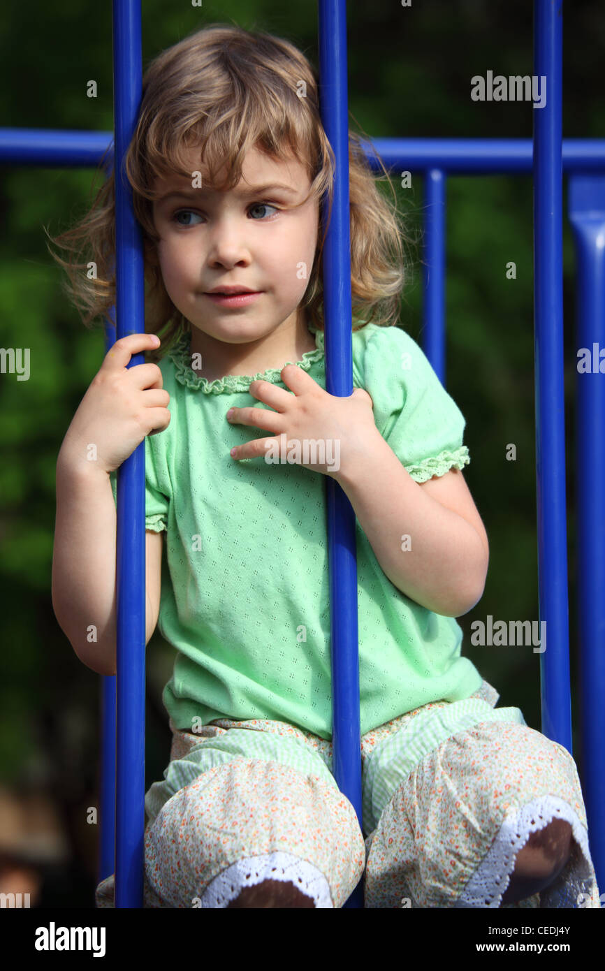 little girl sits keeping for protection rods Stock Photo - Alamy