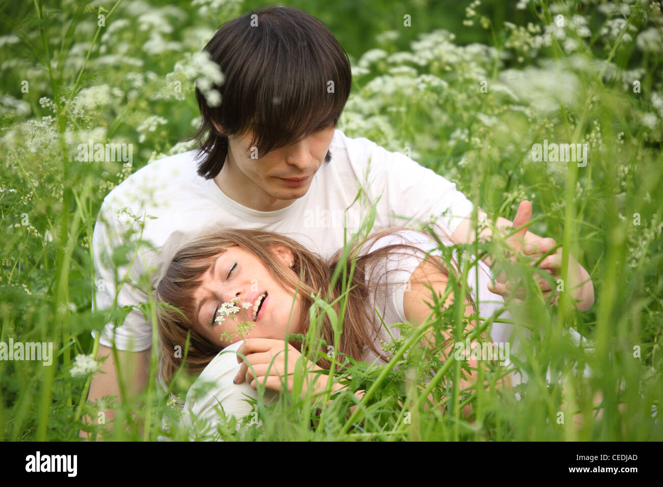 girl lies in lap of guy sitting in grass Stock Photo - Alamy
