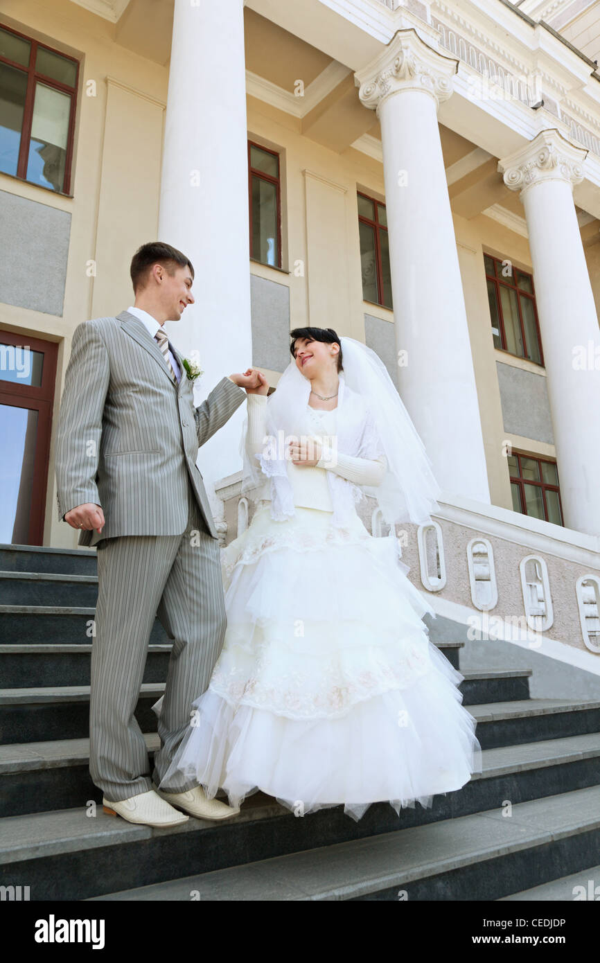 the newly married couple portrait hand by hand on residence ladder ...