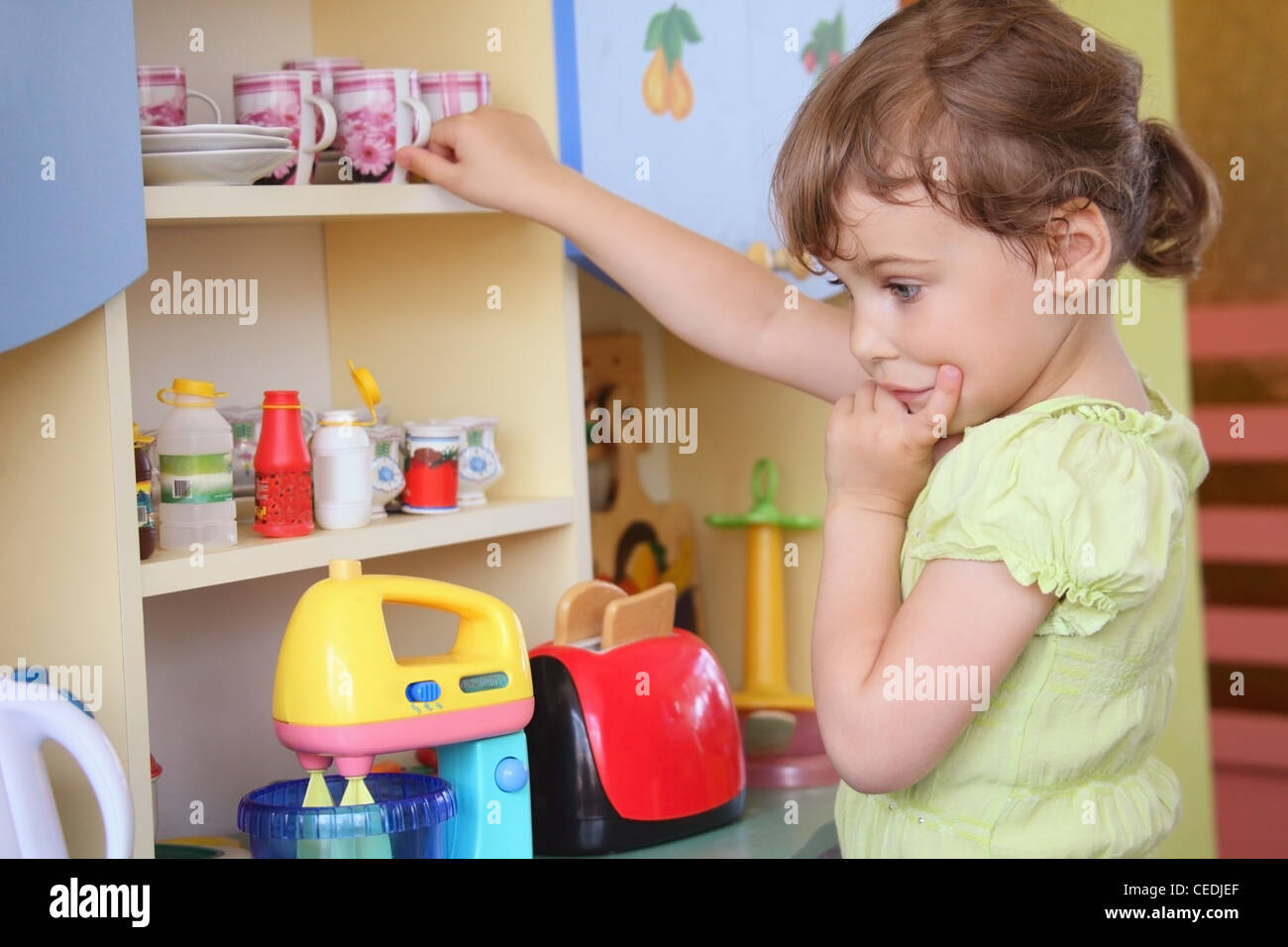 young girl thinking on kitchen Stock Photo - Alamy