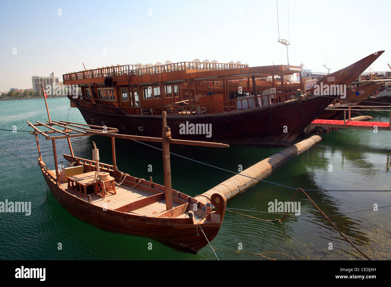 Traditional wooden fishing boats known as Dhow's moored in Doha harbour ...