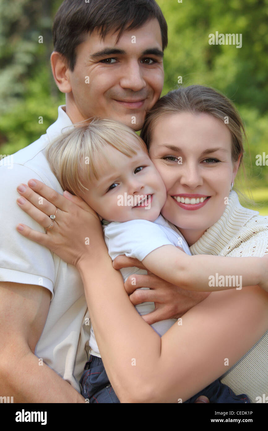 parents hold child on hands outdoor in summer Stock Photo - Alamy