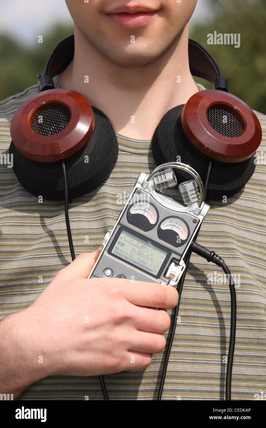Young man with music player and headphones Stock Photo - Alamy