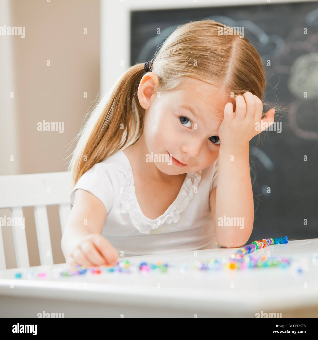 Caucasian girl stringing beads Stock Photo - Alamy