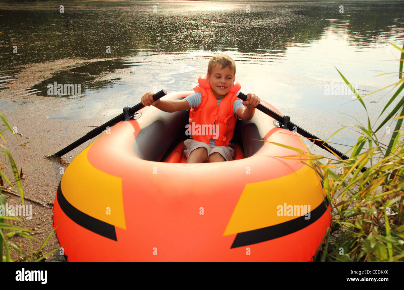 boy in inflatable boat in water Stock Photo - Alamy