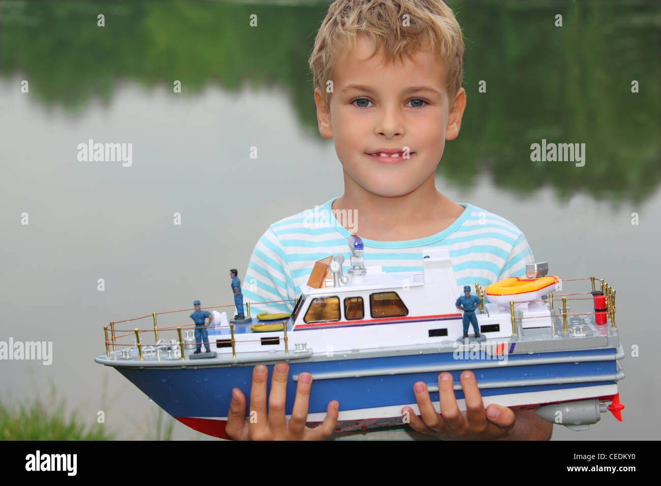 Young boy model ship hi-res stock photography and images - Alamy