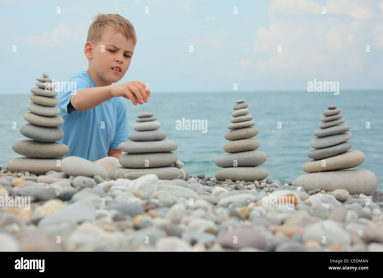 Boy on pebble beach hi-res stock photography and images - Alamy