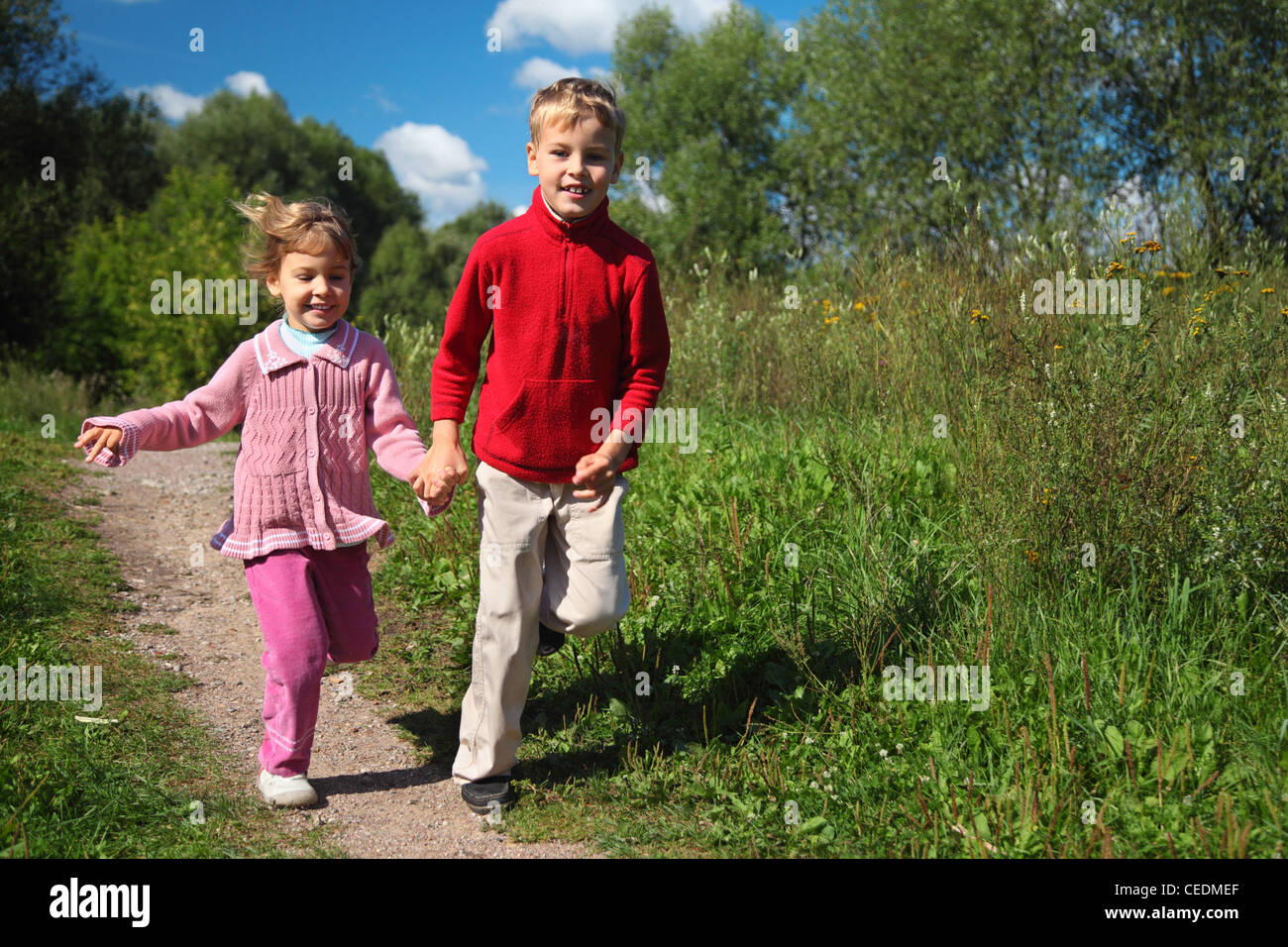 two children run on path in summer Stock Photo - Alamy