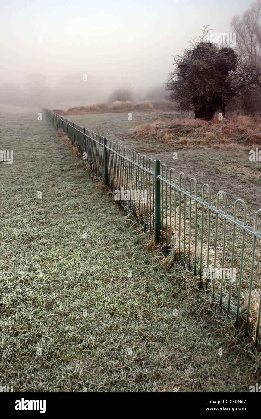 Misty scene with fence Stock Photo - Alamy